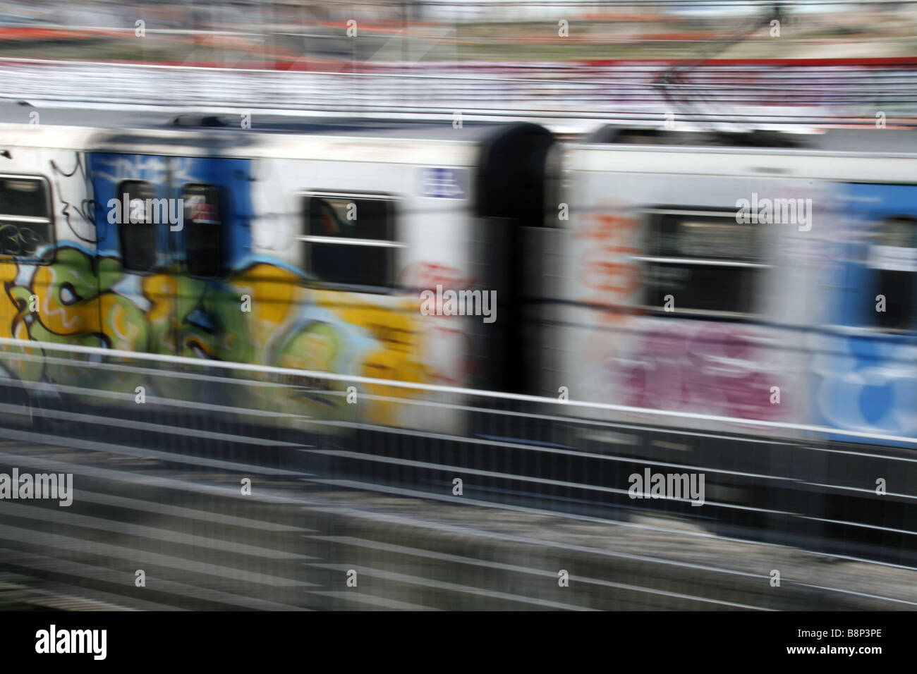 fast metro train covered with graffiti art on tracks in city Stock ...