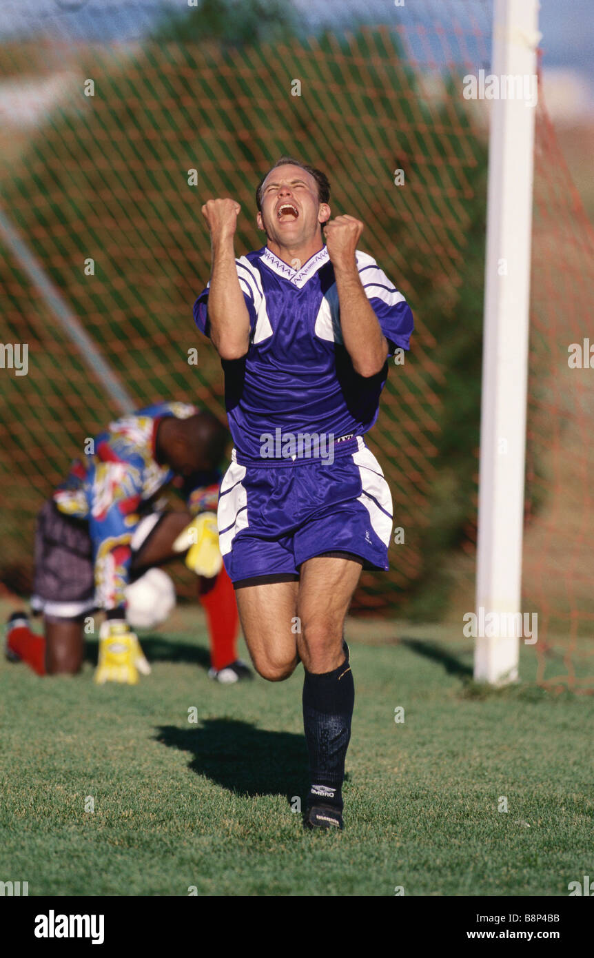 Soccer player celebrating after scoring a goal Stock Photo - Alamy