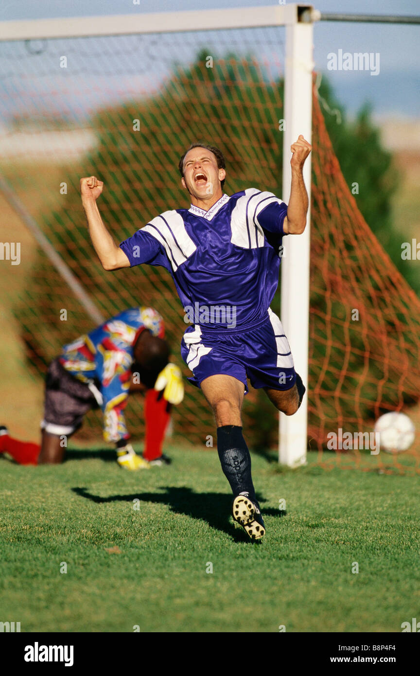 Soccer player celebrating after scoring a goal Stock Photo - Alamy