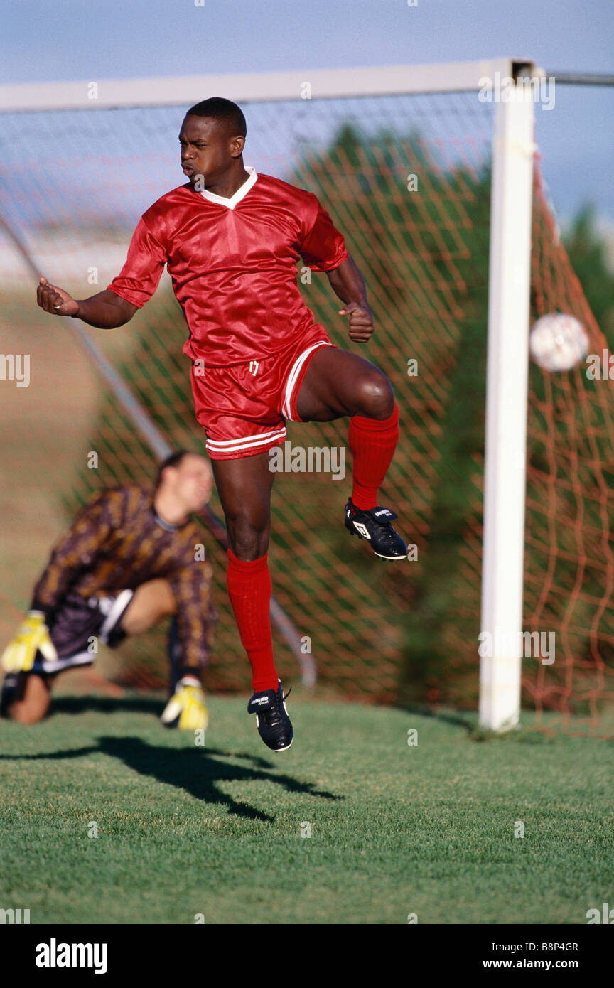 Soccer player celebrating after scoring a goal Stock Photo - Alamy