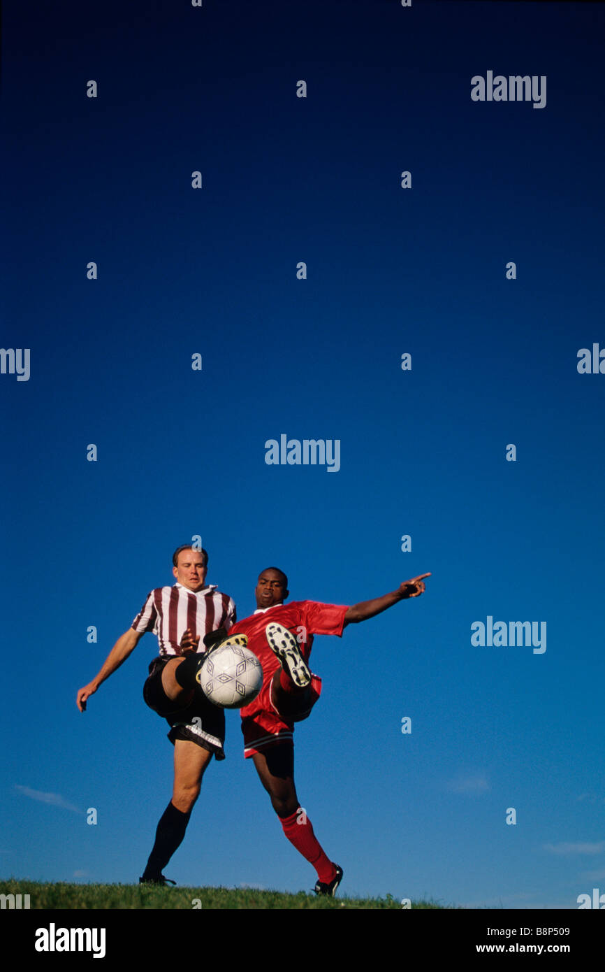 Male soccer players in action Stock Photo - Alamy