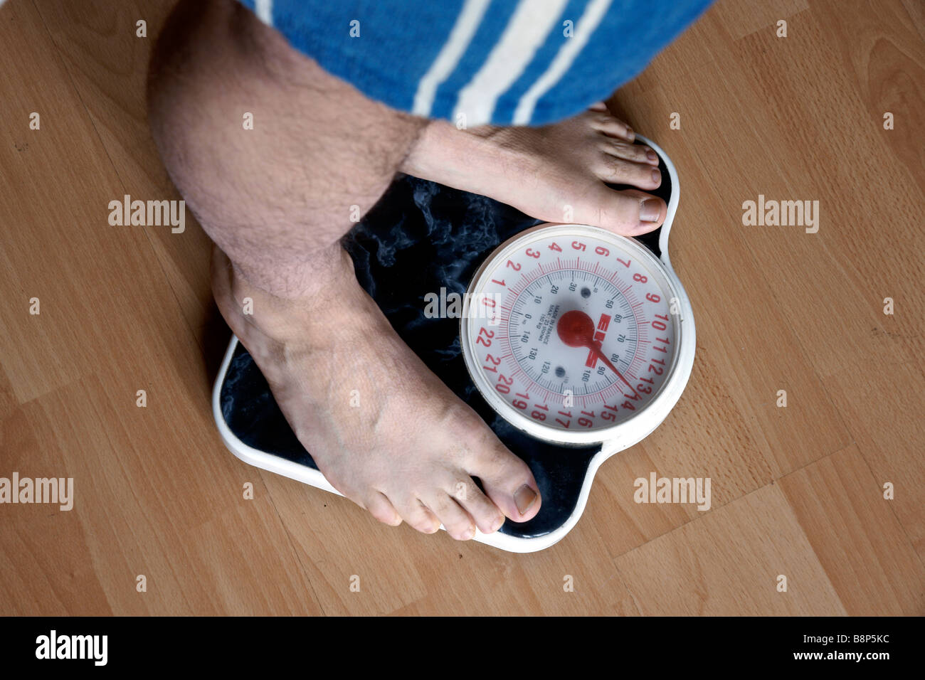 A man weighing himself on a set of scales (c) Marc Jackson Photography ...
