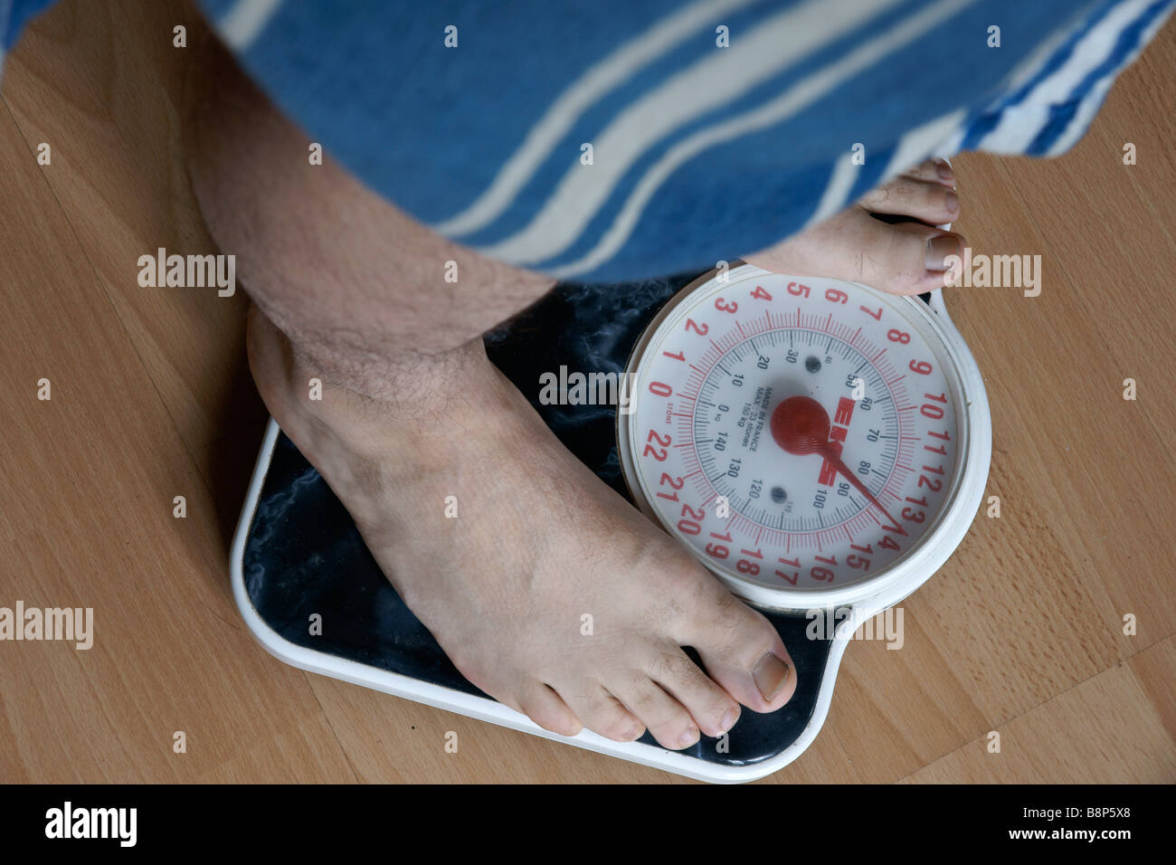 A man weighing himself on a set of scales (c) Marc Jackson Photography ...