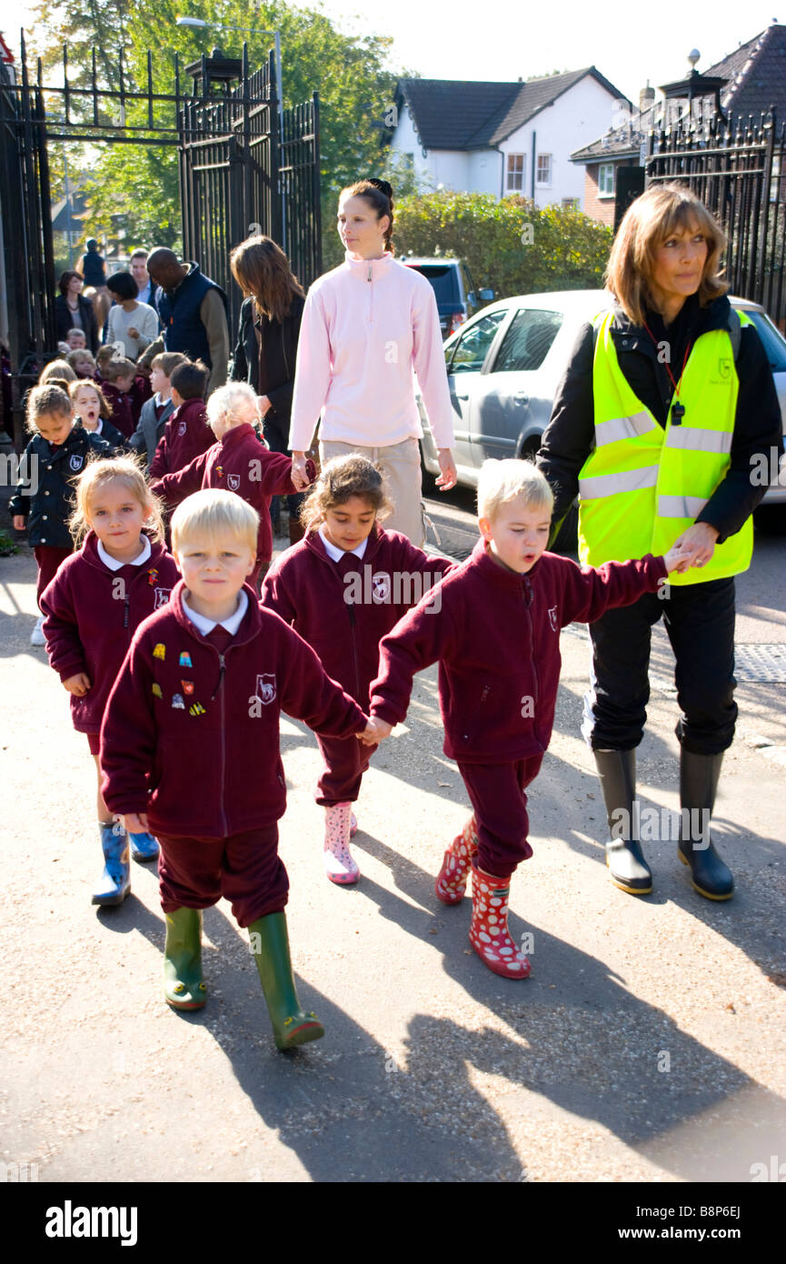 Junior school children on supervised walk with teachers Stock Photo - Alamy