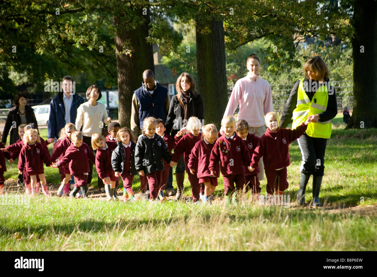 Junior school children on supervised walk with teachers Stock Photo - Alamy