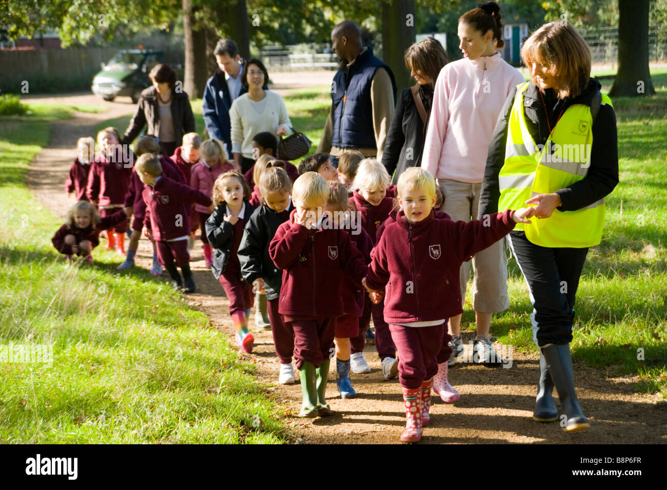 Junior school children on supervised walk with teachers Stock Photo - Alamy