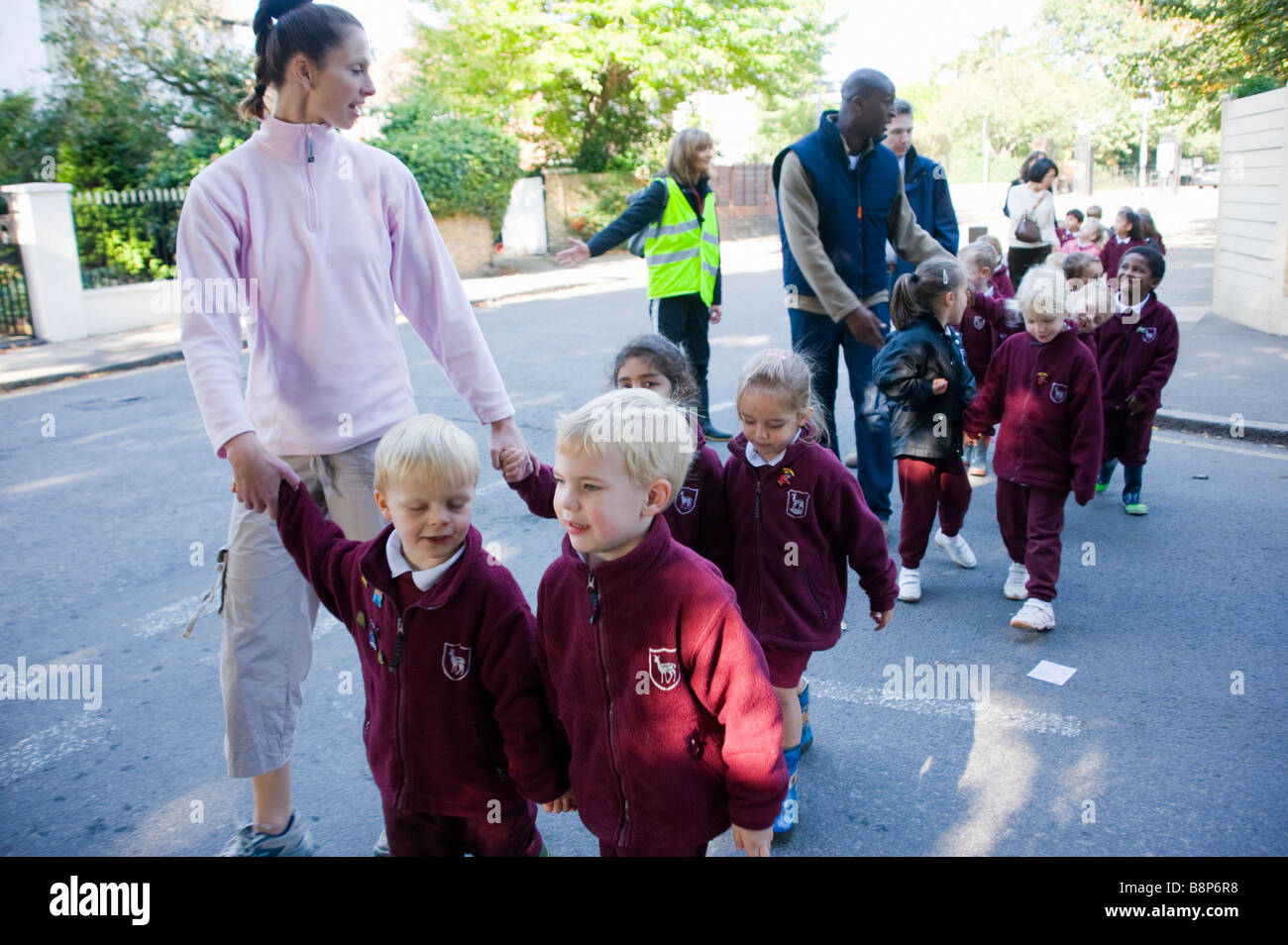 Junior school children on supervised walk with teachers Stock Photo - Alamy