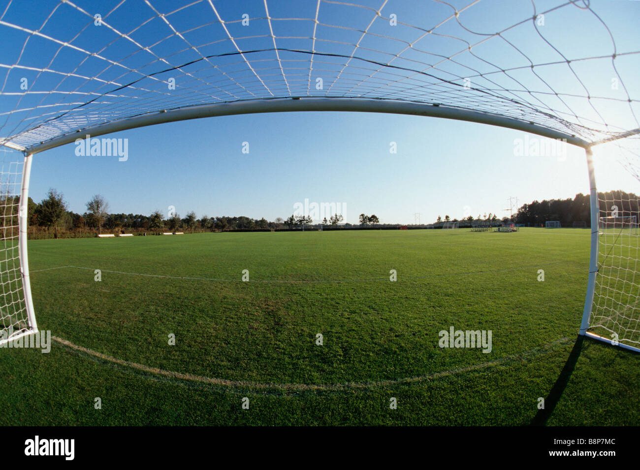 View of soccer field through goal Stock Photo - Alamy