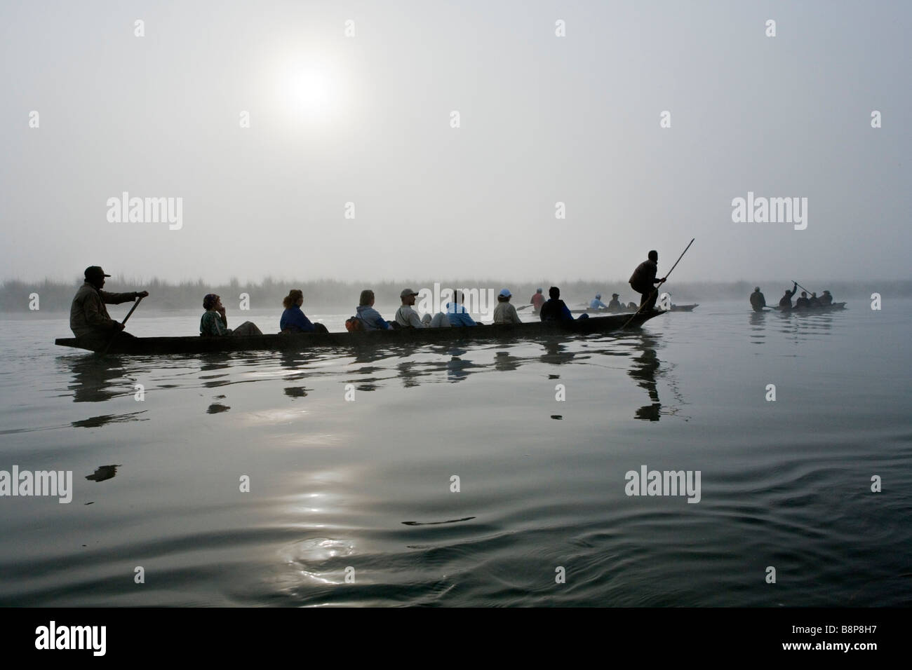 Tourist groups on morning canoe trip on Rapti river in Royal Chitwan ...