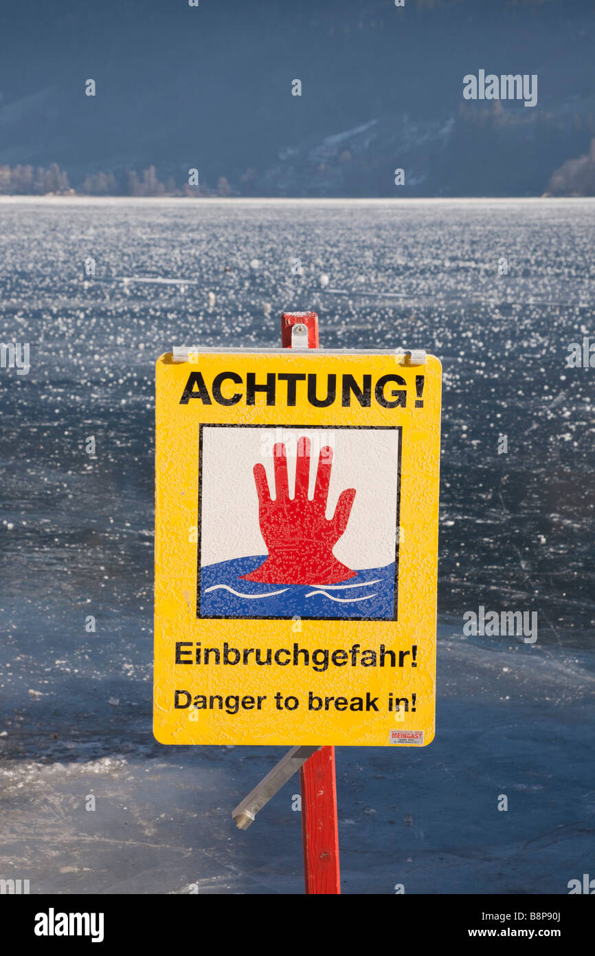 Danger warning sign by ice covered frozen Zeller See lake Austria Stock ...