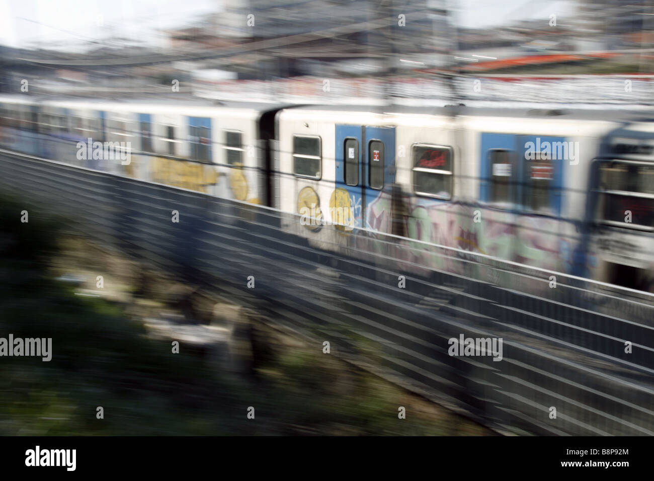 fast metro train covered with graffiti art on tracks in city Stock ...