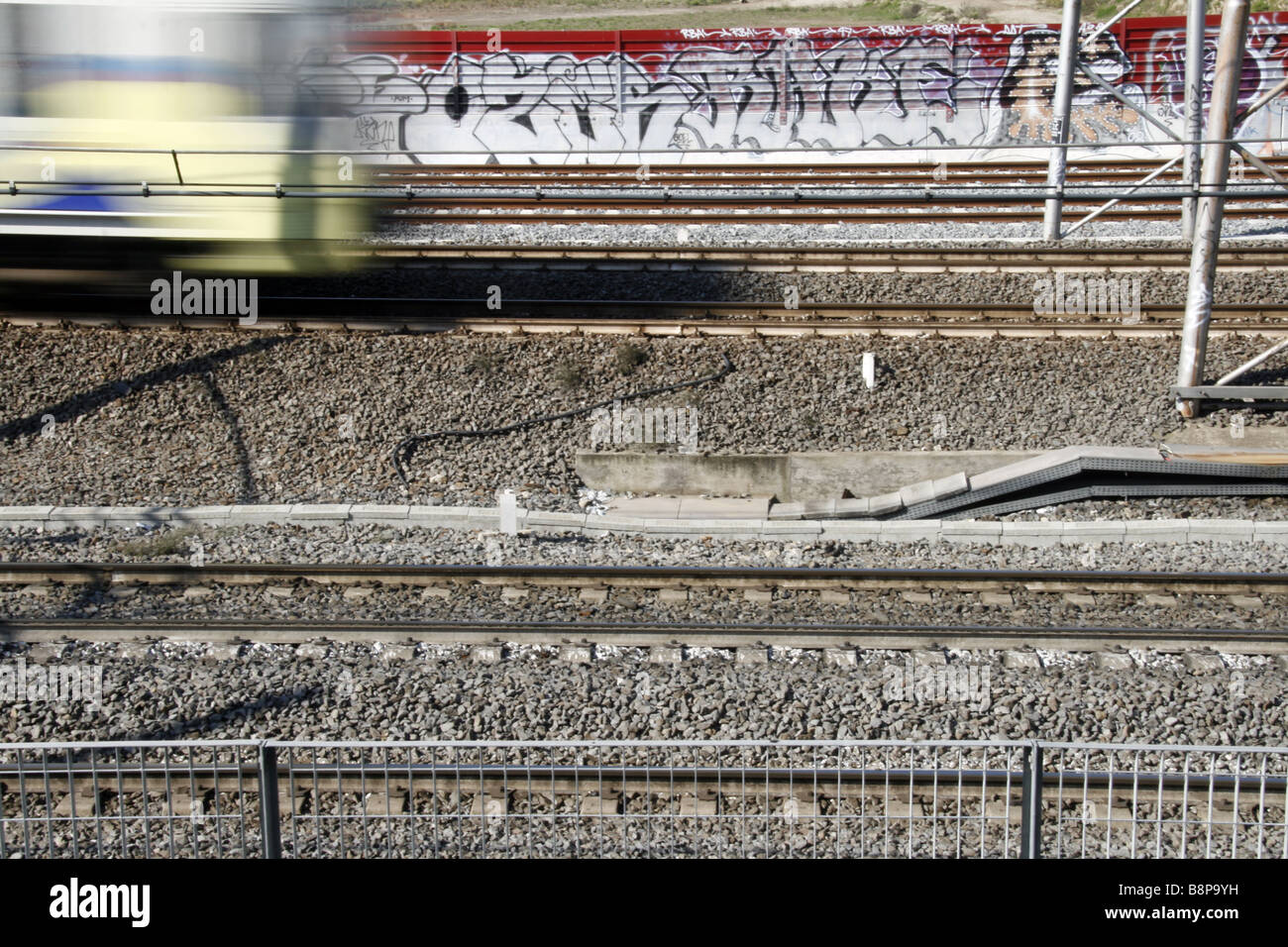 fast metro train covered with graffiti art on tracks in city Stock ...