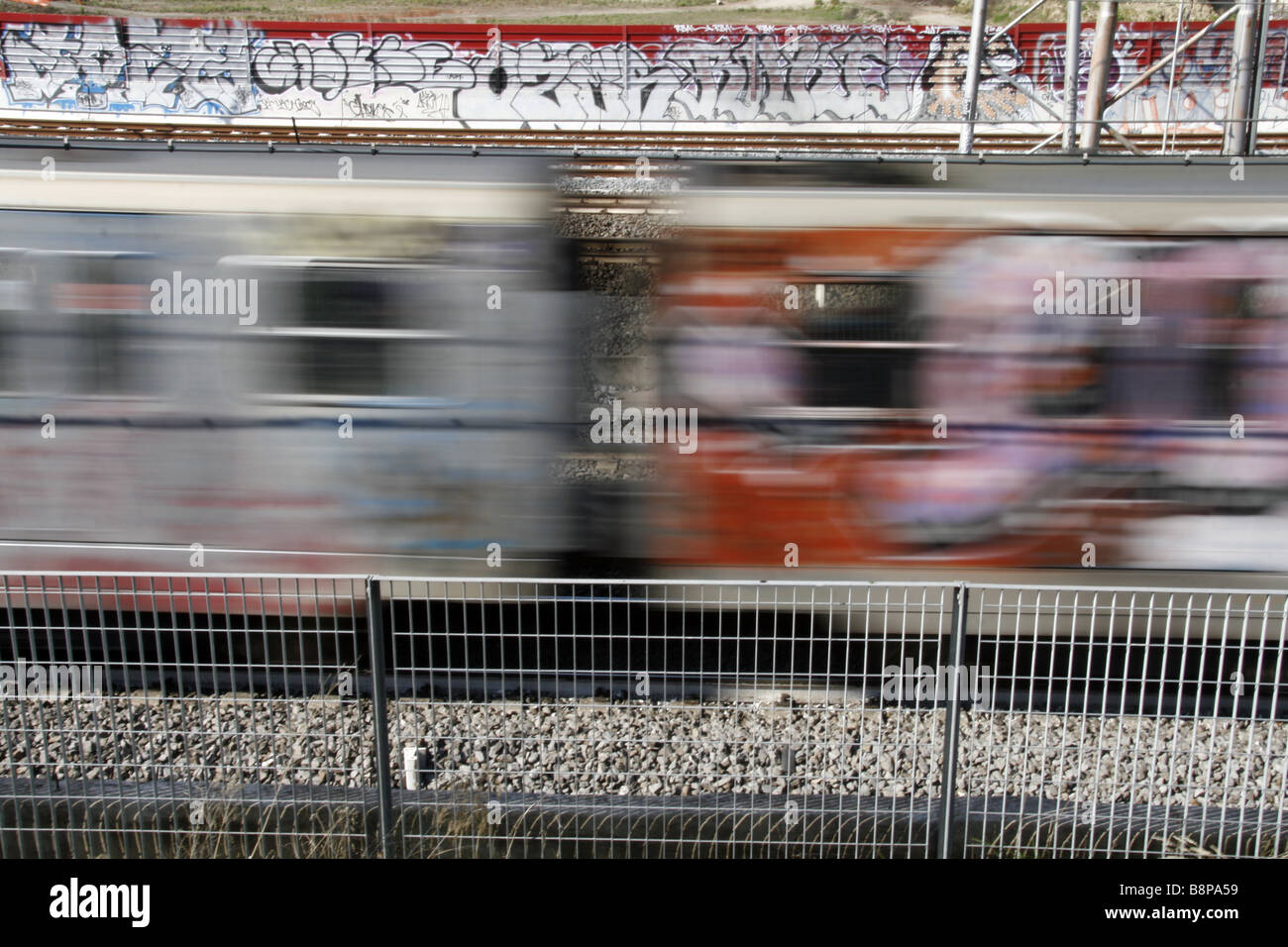 fast metro train covered with graffiti art on tracks in city Stock ...