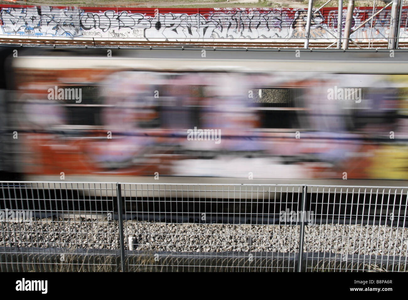 fast metro train covered with graffiti art on tracks in city Stock ...