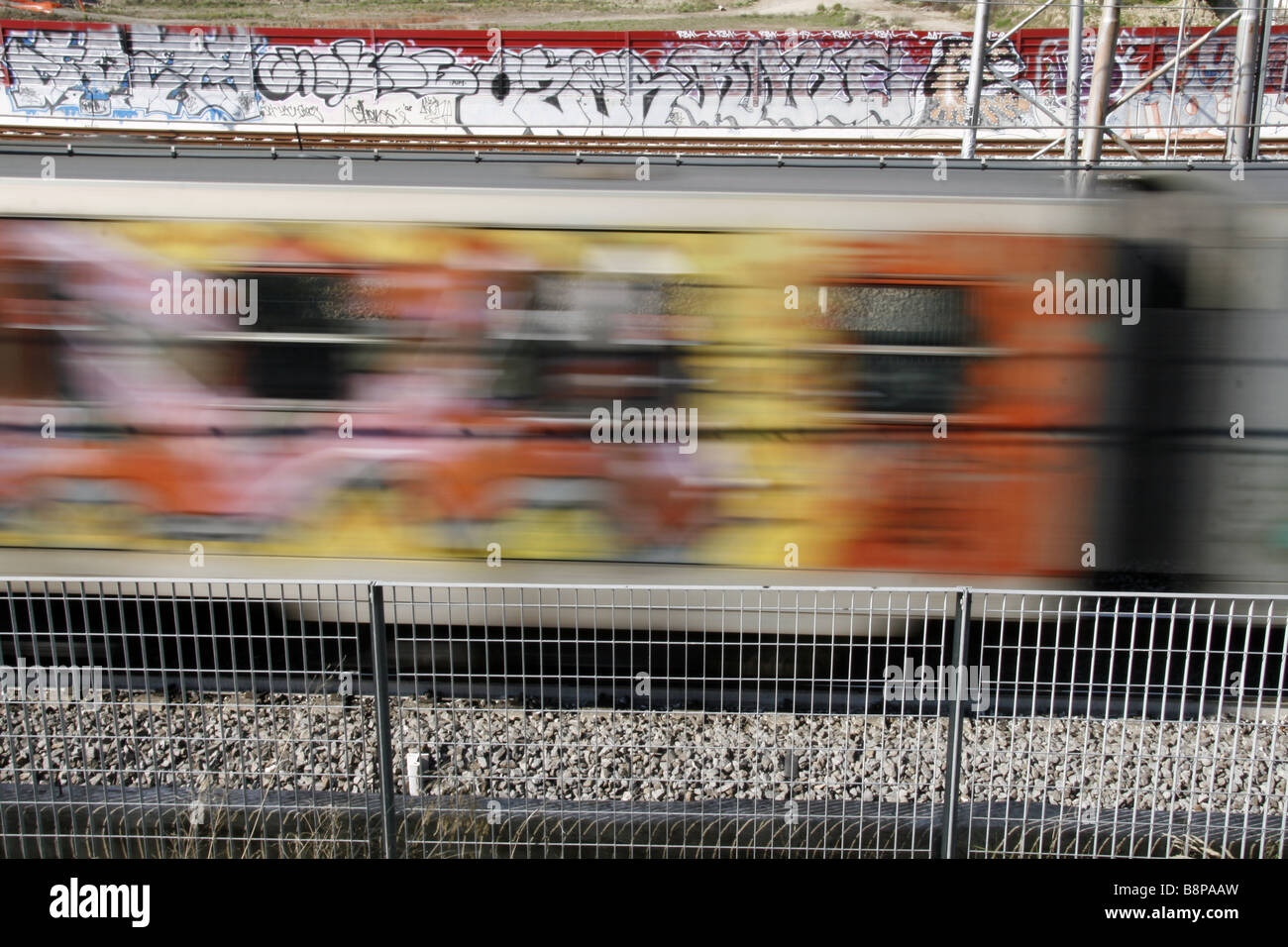 fast metro train covered with graffiti art on tracks in city Stock ...