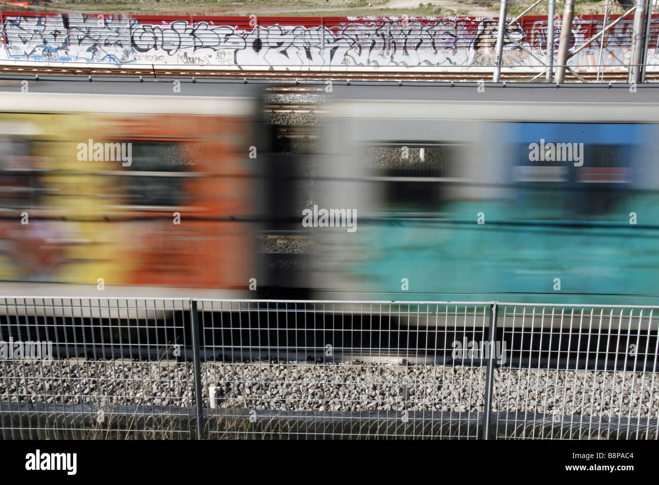 fast metro train covered with graffiti art on tracks in city Stock ...
