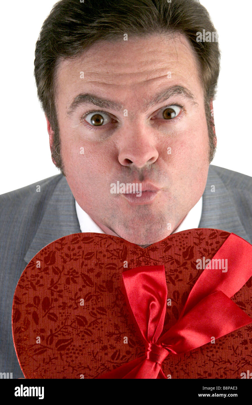 Handsome man in a suit with valentine candy Stock Photo - Alamy