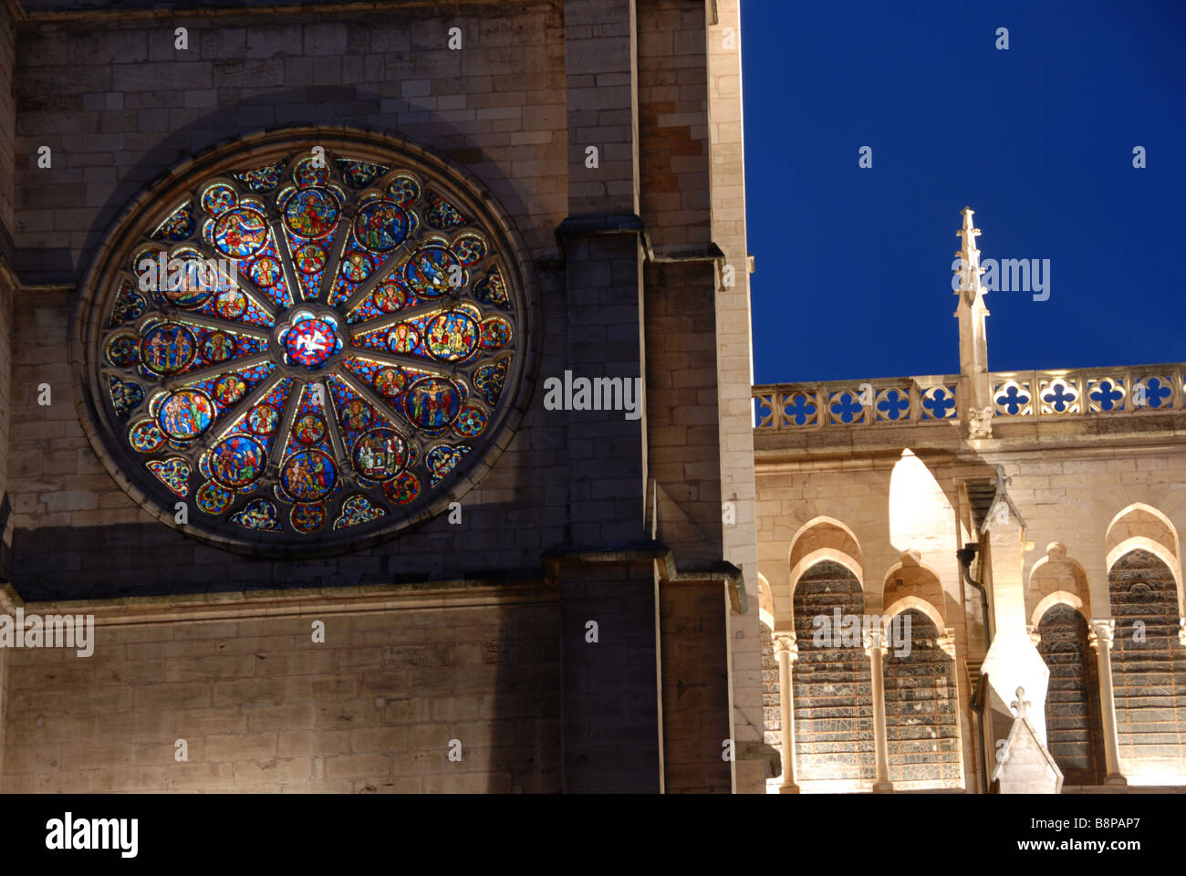 A floodlit colourful stain glass window on the Cathedral Saint Jean in ...