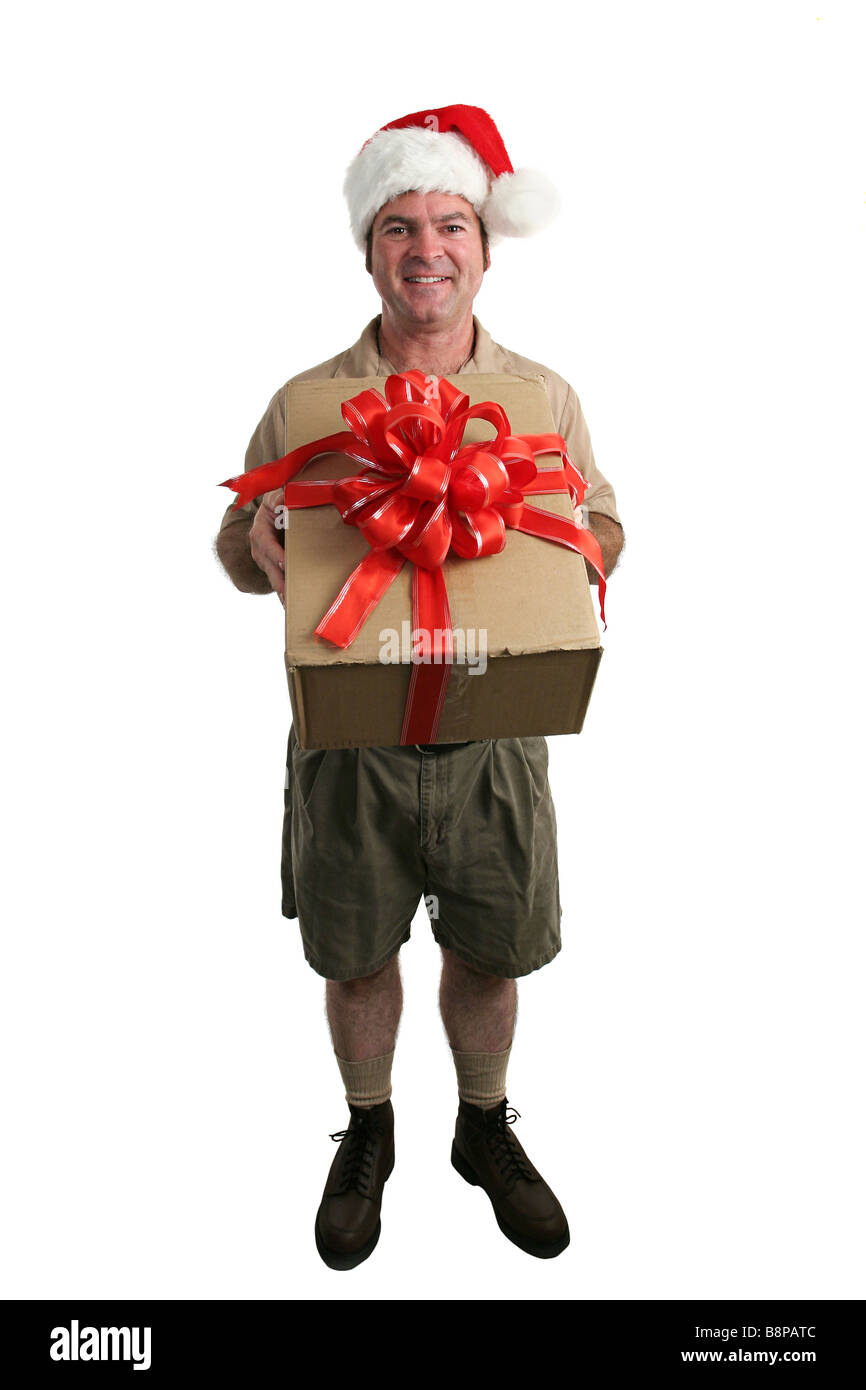 A full view of a delivery man with a Santa hat delivering a gift ...