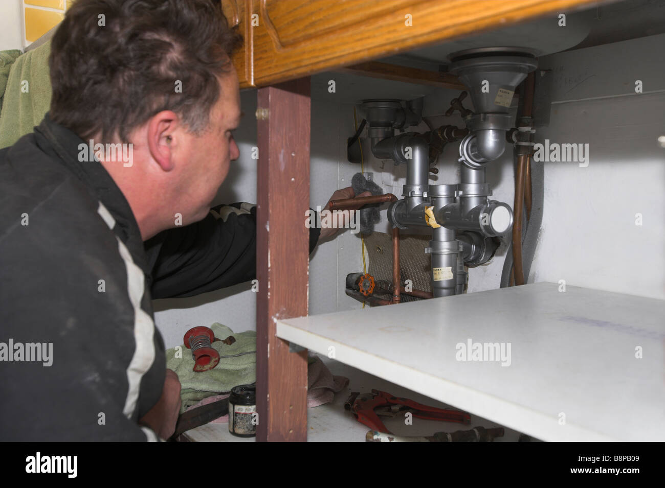 Plumber cleaning pipe for soldering Stock Photo - Alamy