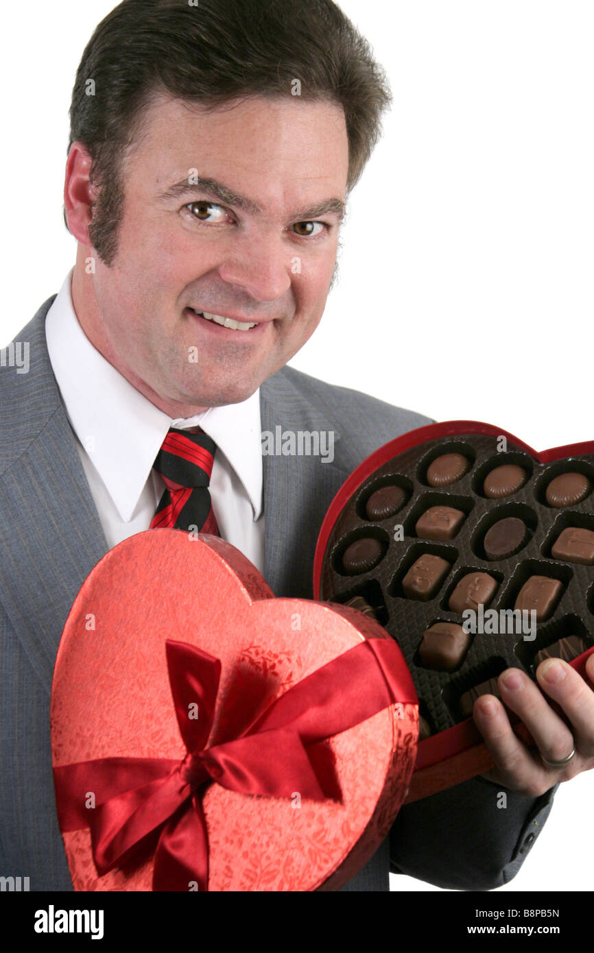 Closeup portrait of a handsome well dressed man holding a box of ...