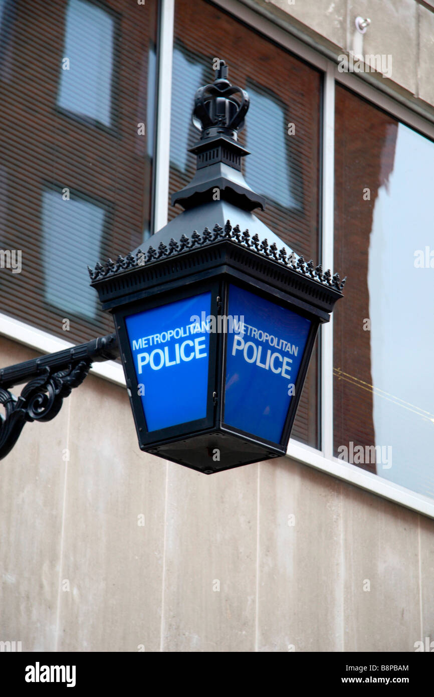 A traditional blue lamp outside a Metropolitan Police station in London ...