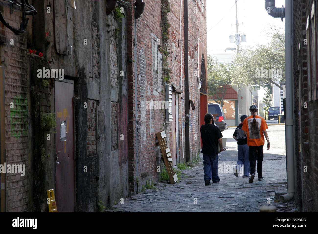 Man walking down back alley hi-res stock photography and images - Alamy