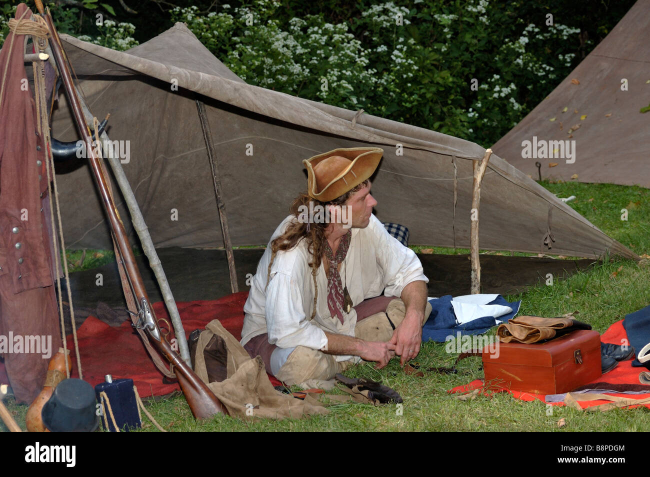 Pioneer in camp with flintlock rifle at the Siege of Boonesborough ...