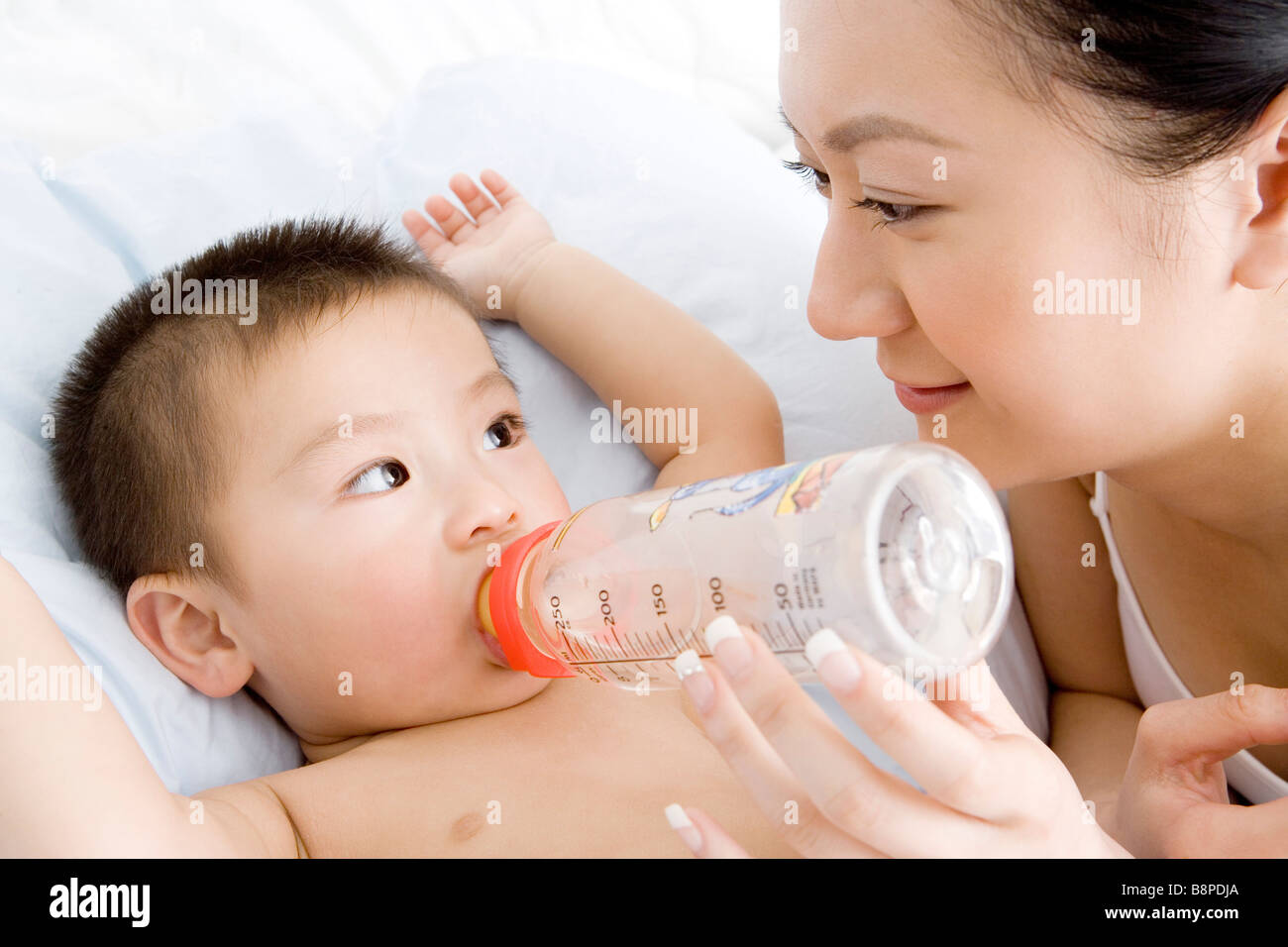 Baby boy drinking from bottle Stock Photo - Alamy