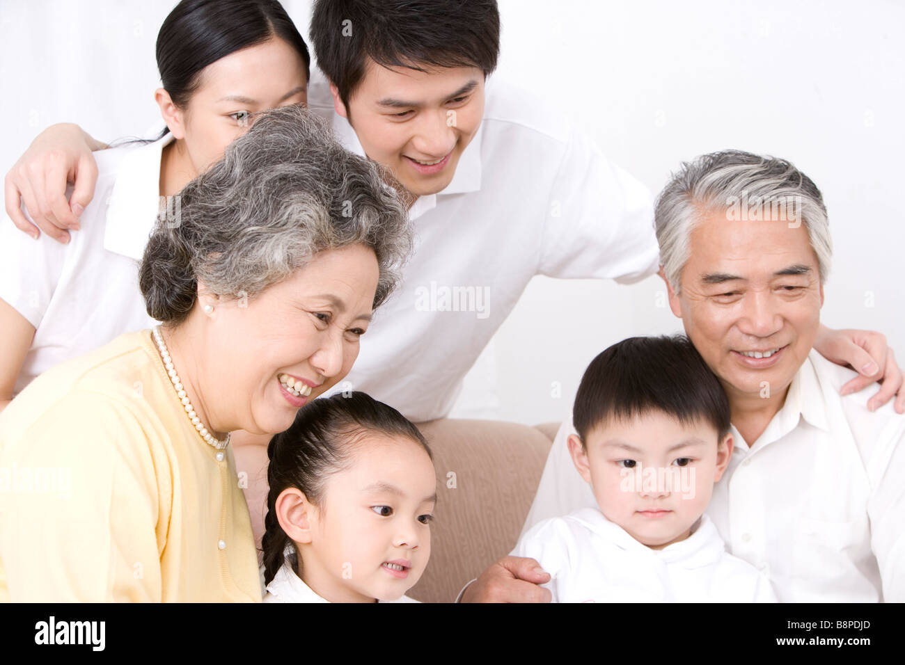 Three generation family by sofa Stock Photo - Alamy
