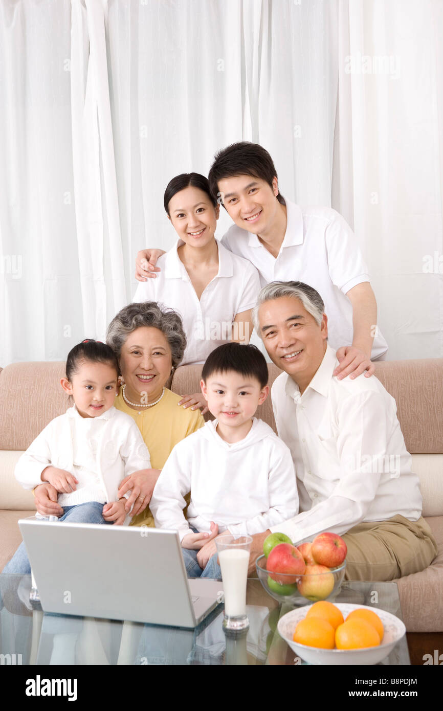 Three generation family by sofa smiling portrait Stock Photo - Alamy