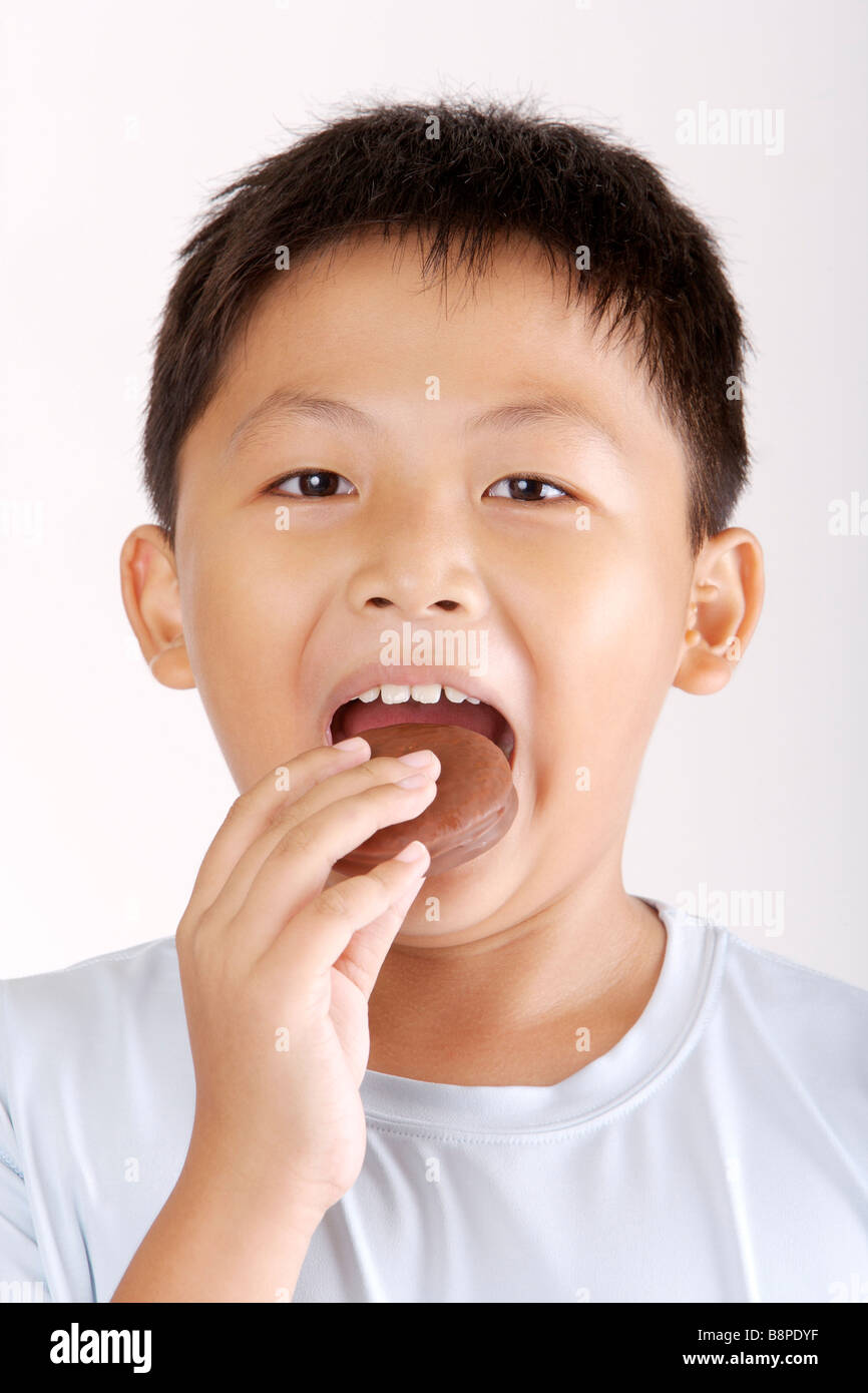 Boy eating food portrait Stock Photo - Alamy