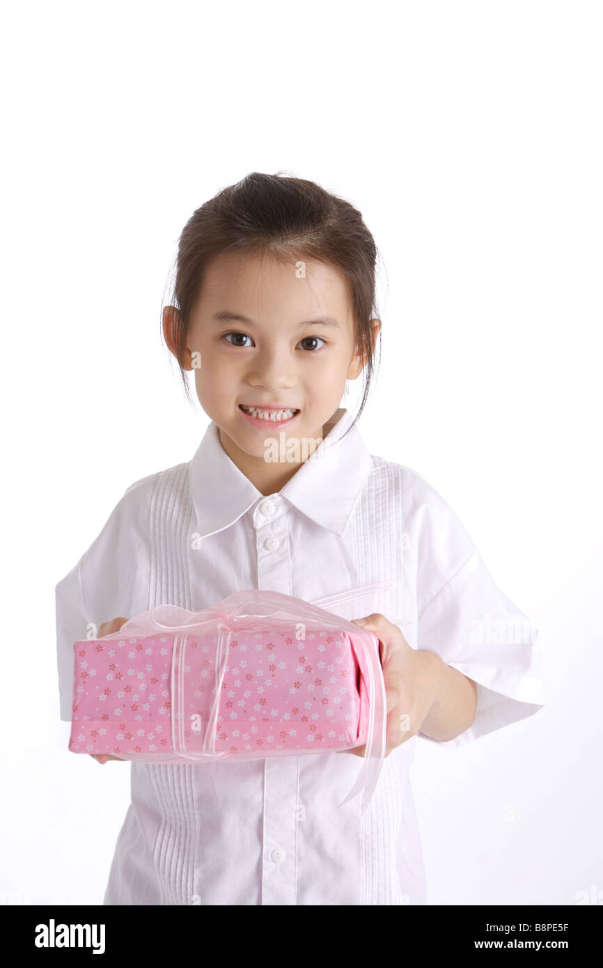 Girl holding wrapped gift portrait Stock Photo - Alamy