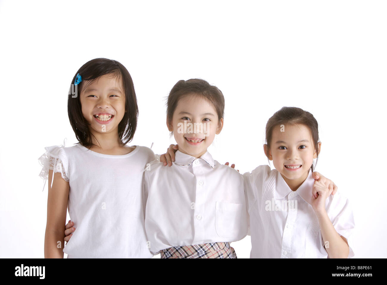 Three girls standing together smiling portrait Stock Photo - Alamy