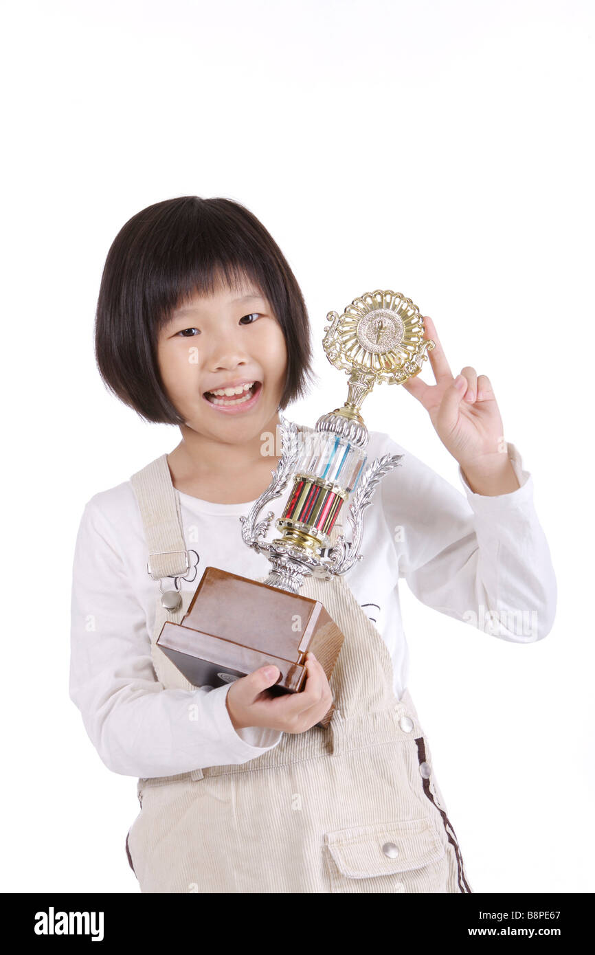 Girl holding trophy smiling portrait Stock Photo - Alamy