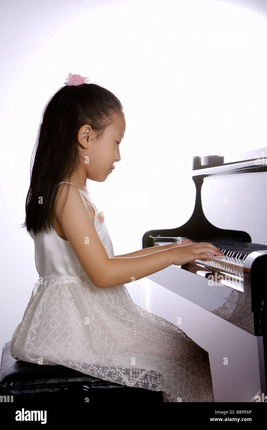 Side profile of a girl playing the piano Stock Photo - Alamy