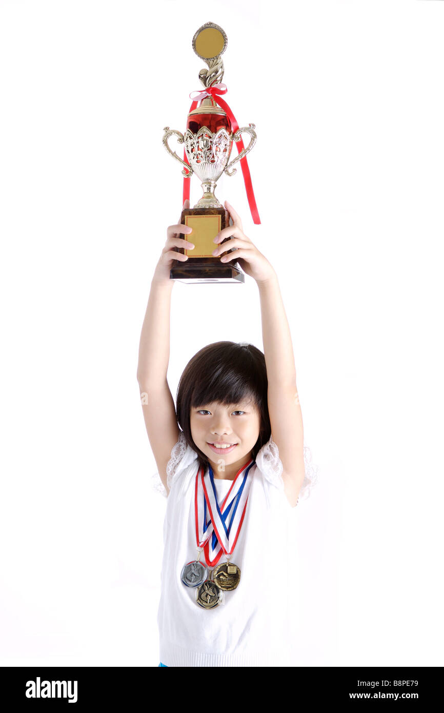 Girl lifting trophy portrait Stock Photo - Alamy
