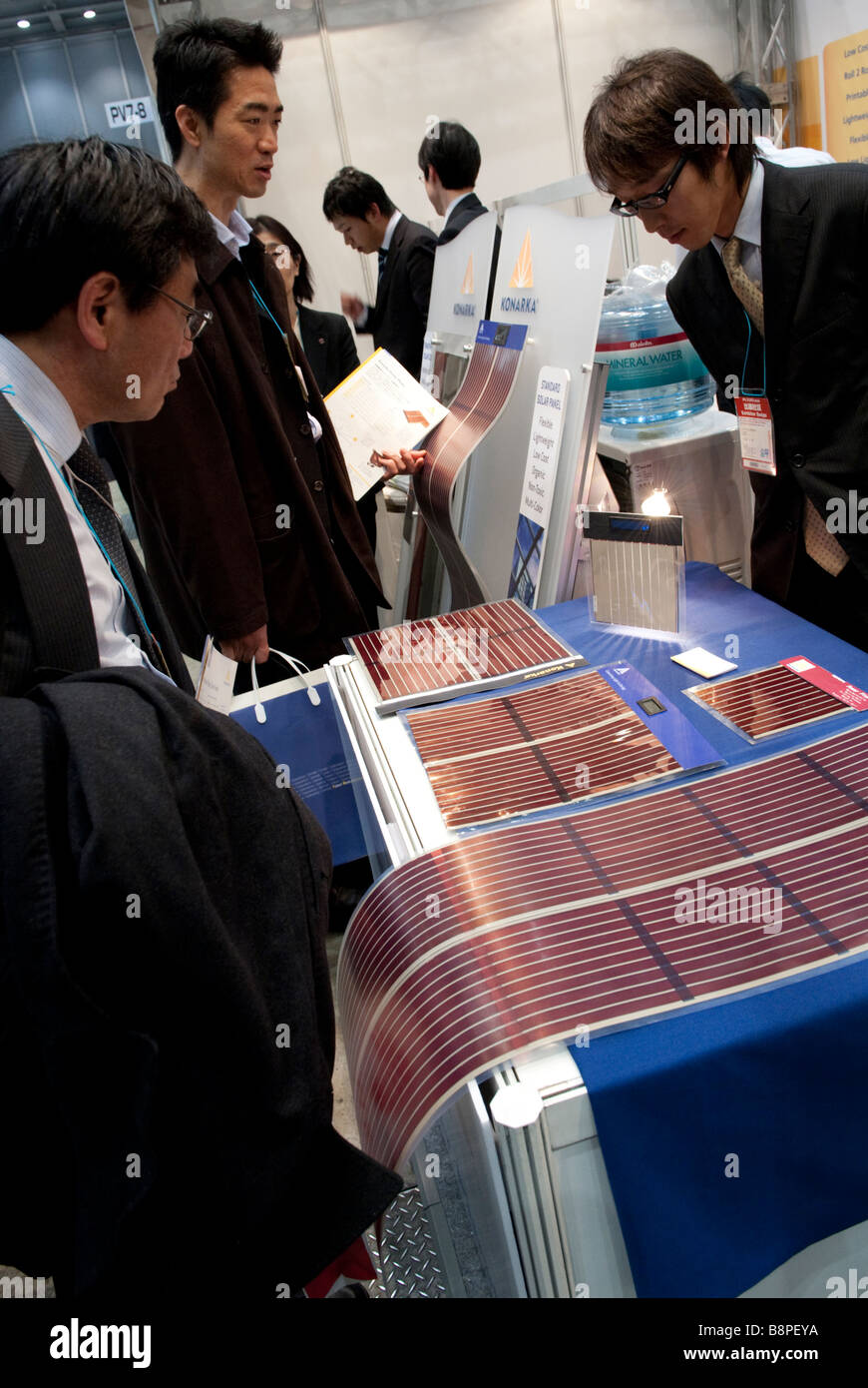 Visitors looking at flexible thin solar cells at the PV Expo 2009 ...
