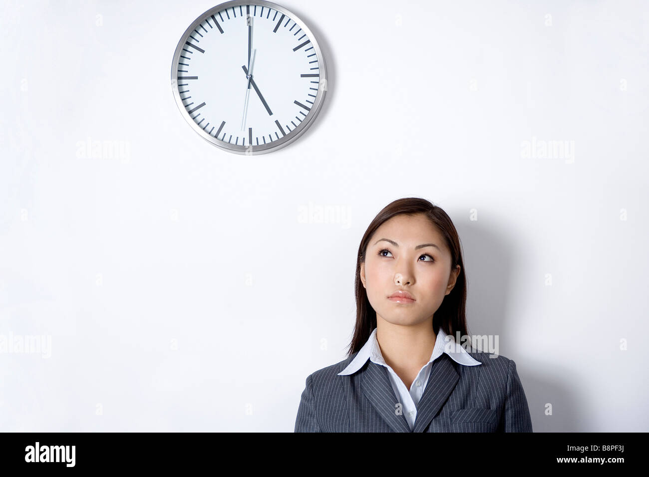 Clock watching woman office hi-res stock photography and images - Alamy