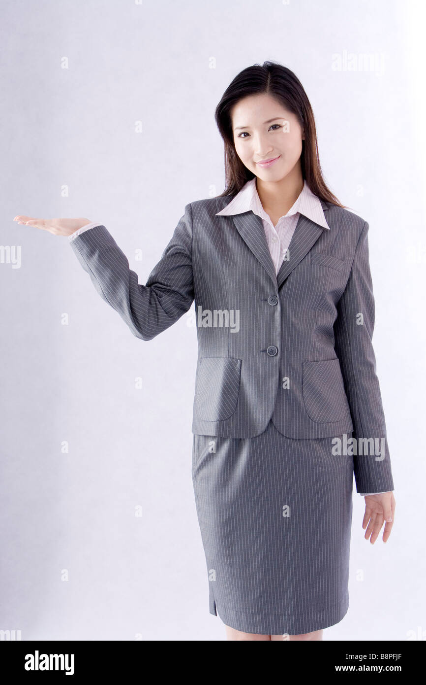 Young businesswoman showing service gesture smiling portrait Stock ...