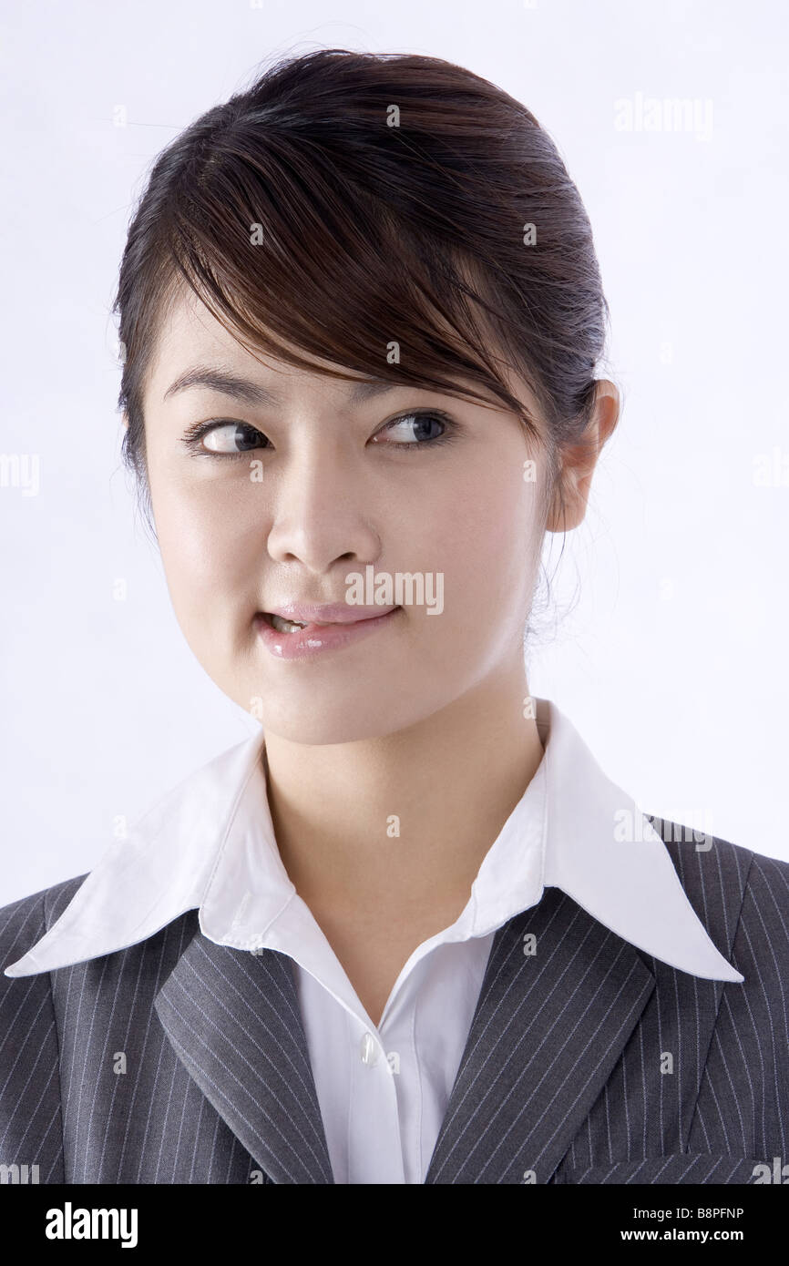 Woman biting lower lip portrait Stock Photo - Alamy