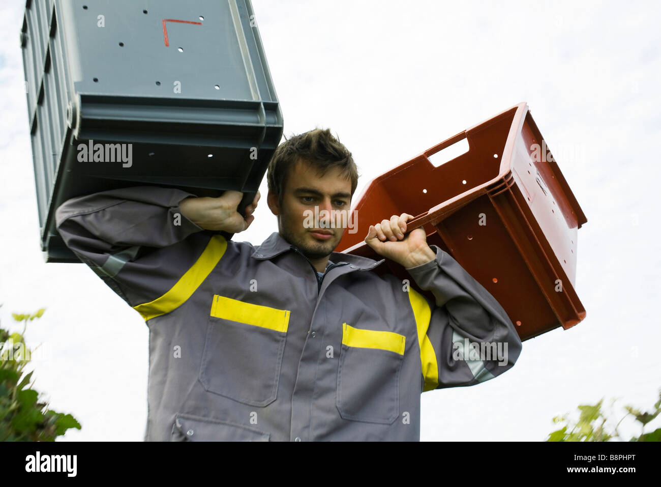 Man carrying plastic containers hi-res stock photography and images - Alamy