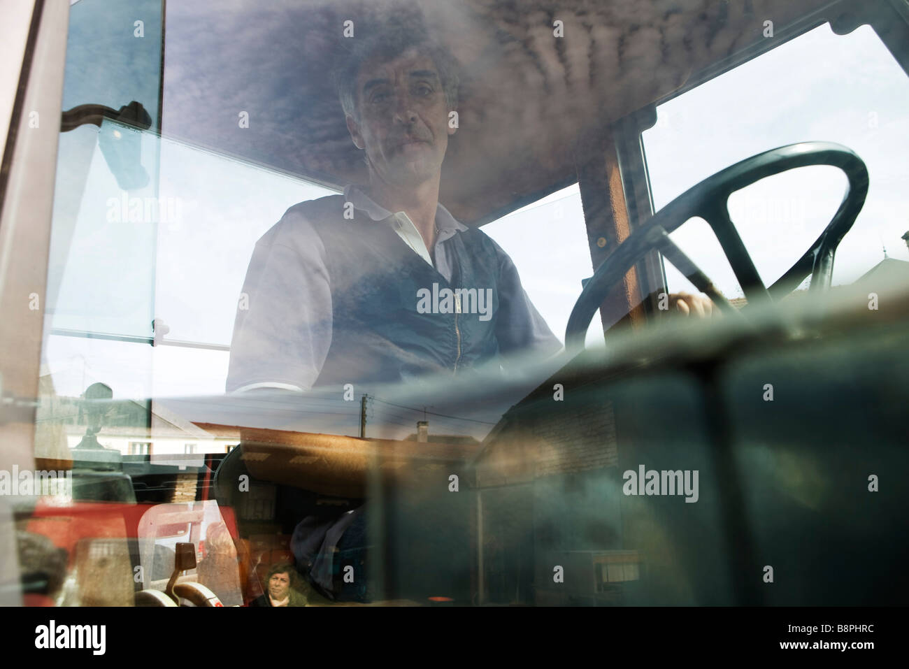 France, Champagne-Ardenne, Aube, farmer sitting in tractor, portrait ...
