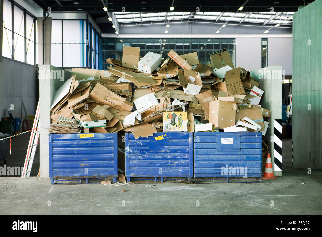 Bins overflowing with cardboard in recycling center Stock Photo - Alamy