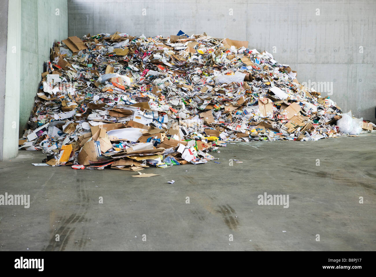 Paper and cardboard piled up in recycling center Stock Photo - Alamy