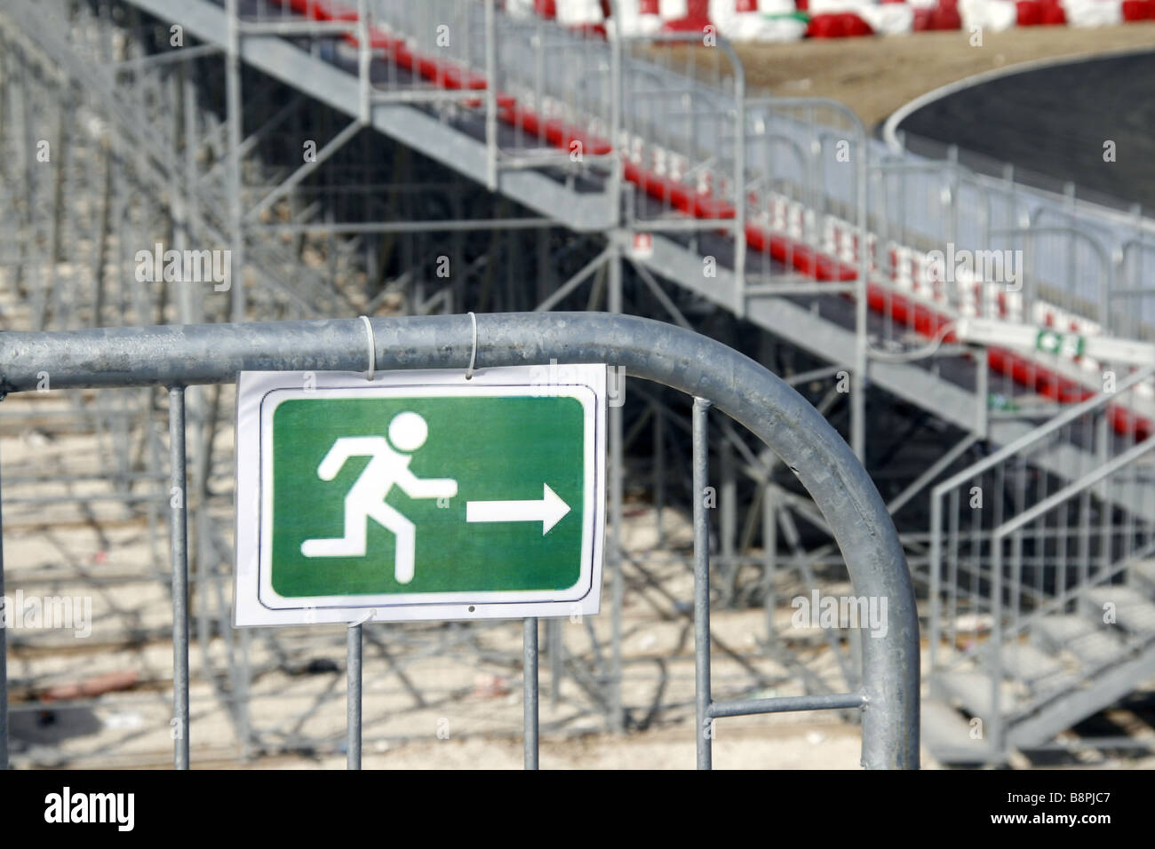 emergency exit sign on barrier fence outdoors at sports arena Stock ...
