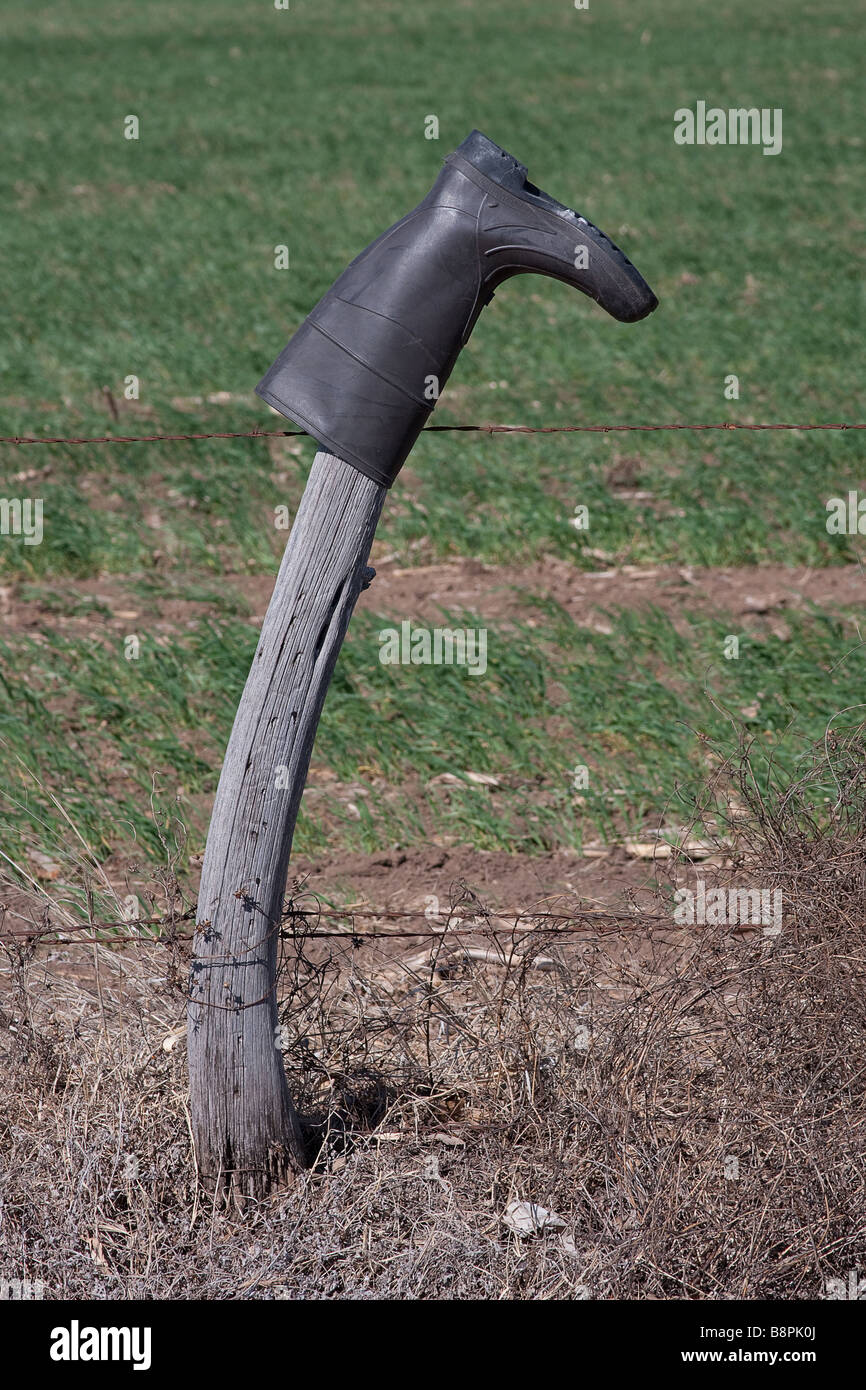 Boot on a fence post Stock Photo - Alamy