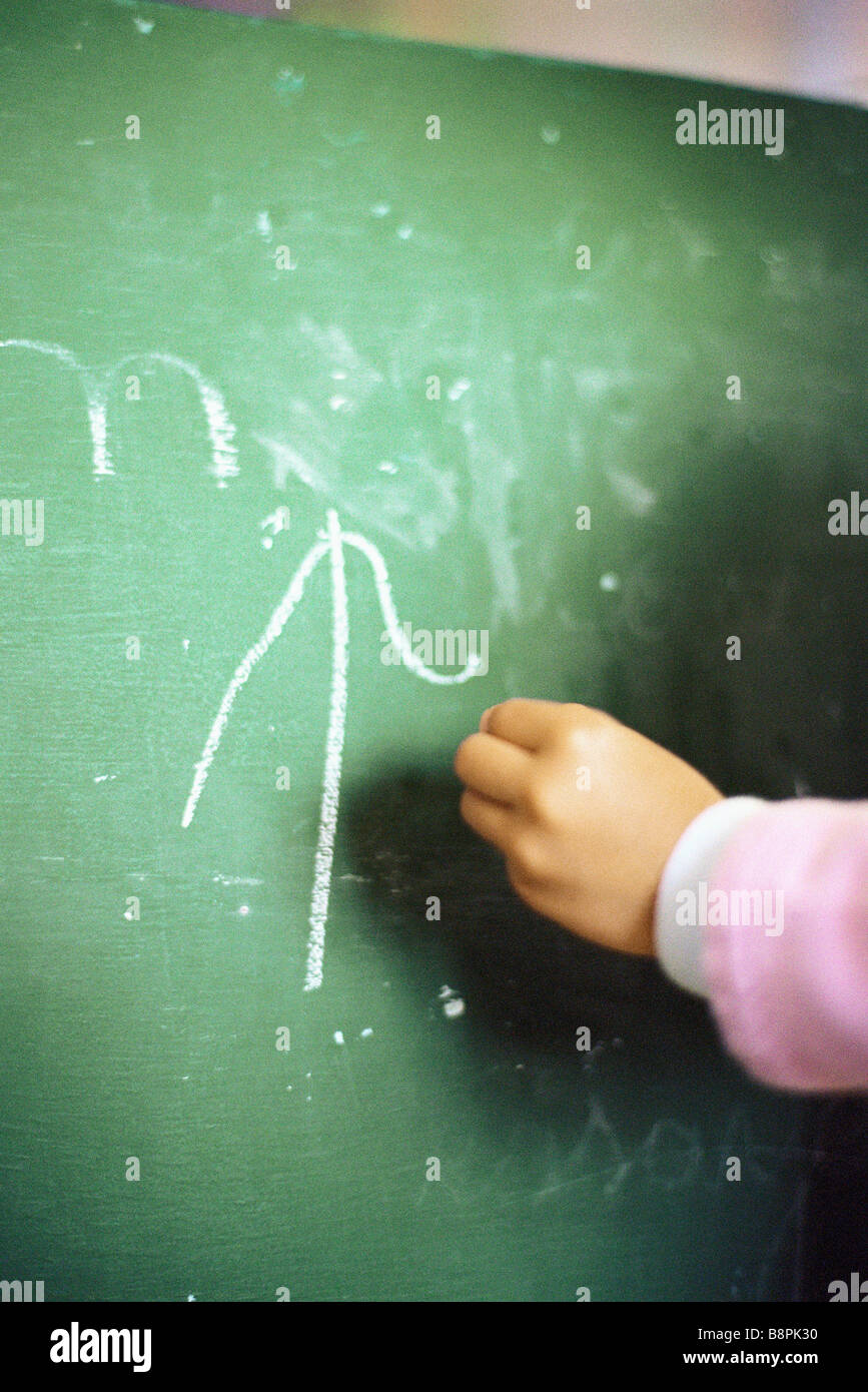 Child's hand writing on chalk board Stock Photo - Alamy