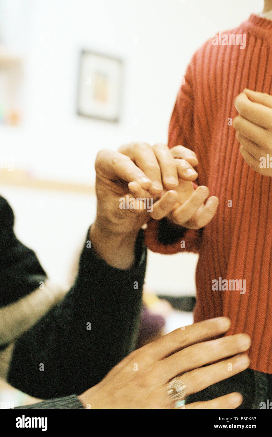 Person examining child's hand, cropped view Stock Photo - Alamy