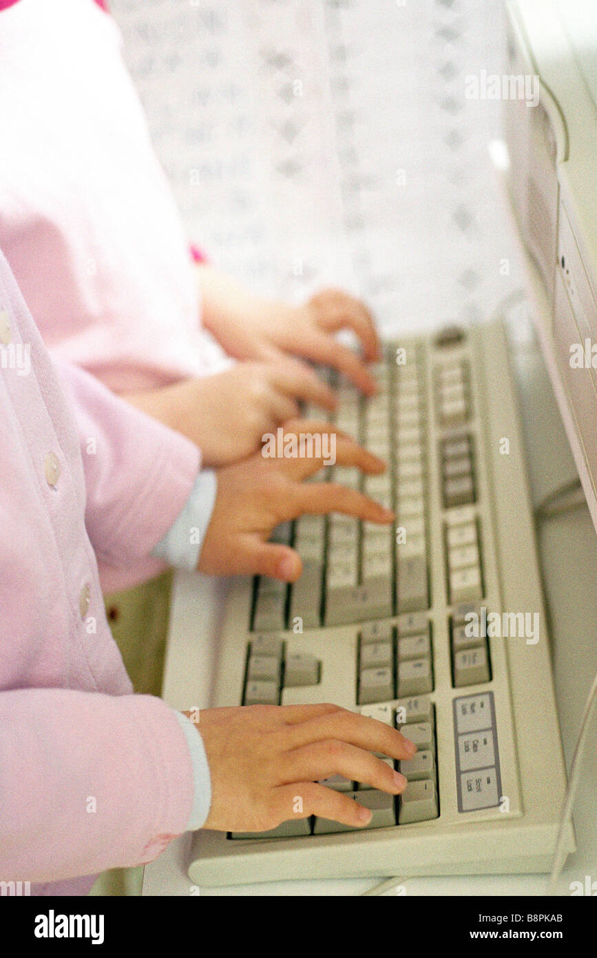 Children typing on keyboard, cropped view of hands Stock Photo - Alamy